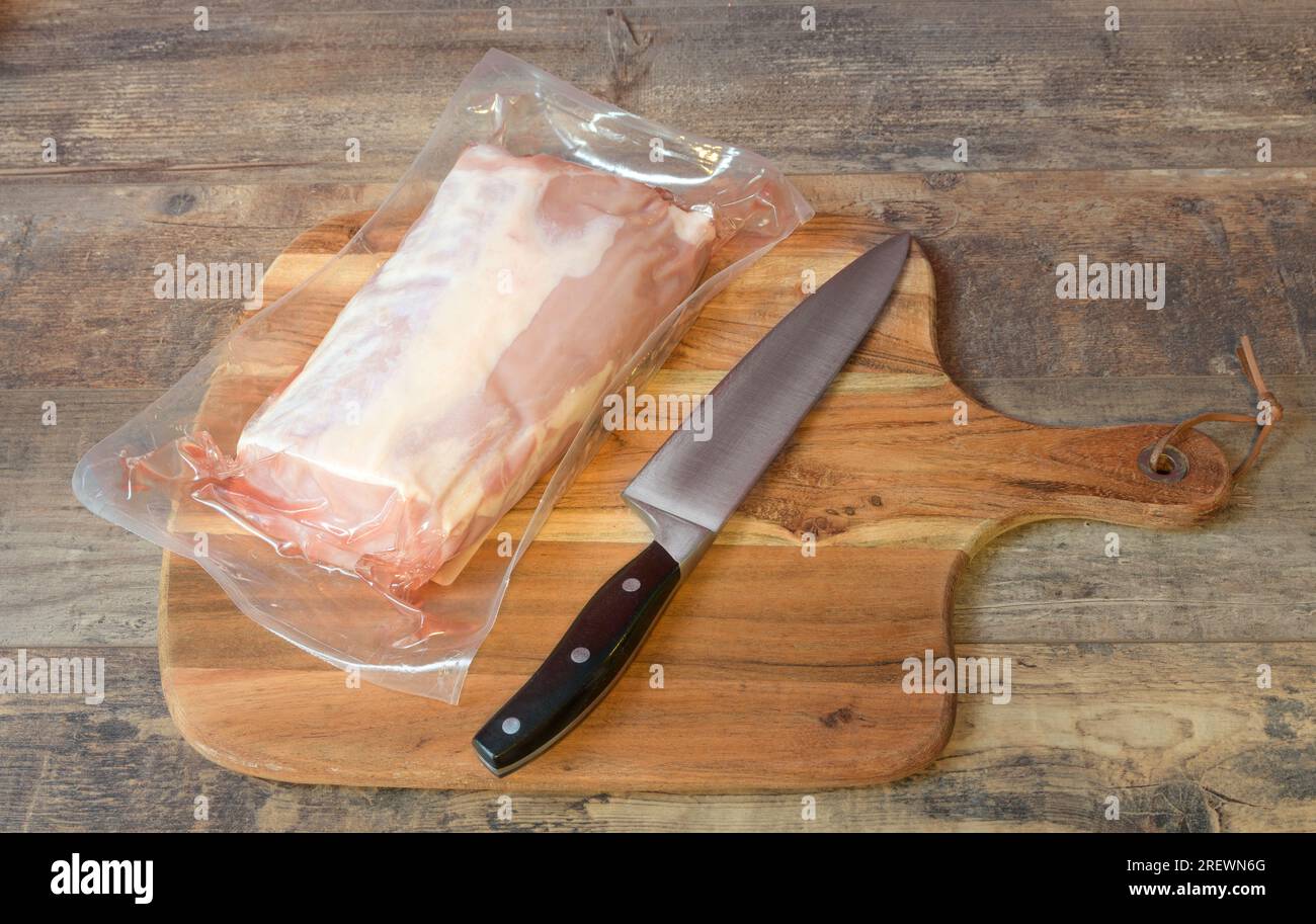 Vacuum packaging along with meat. Remove the piece of meat from the ...