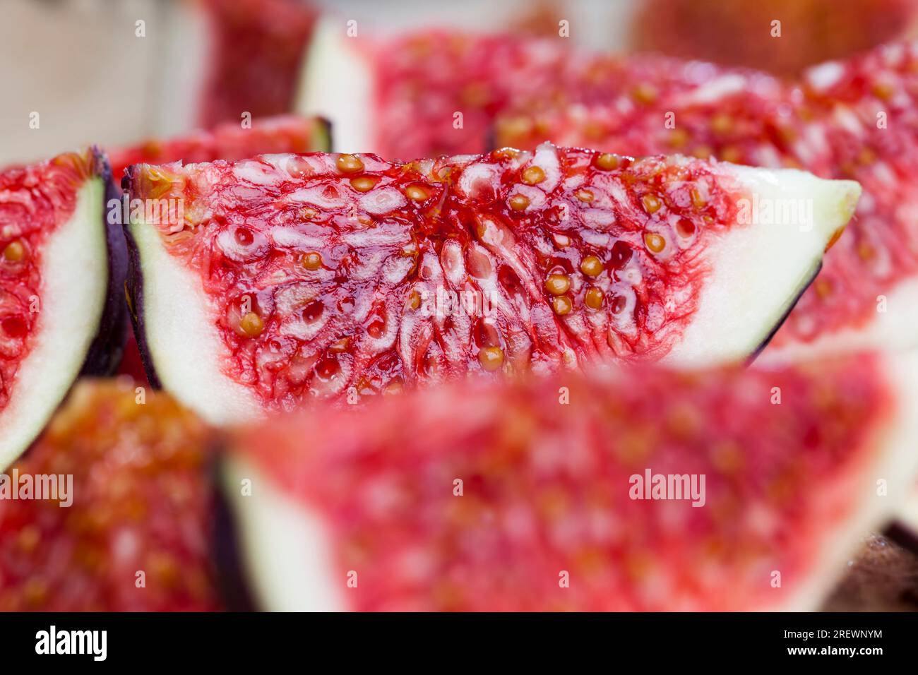 bright red delicious fig pulp with seeds, ripe figs cut into several ...