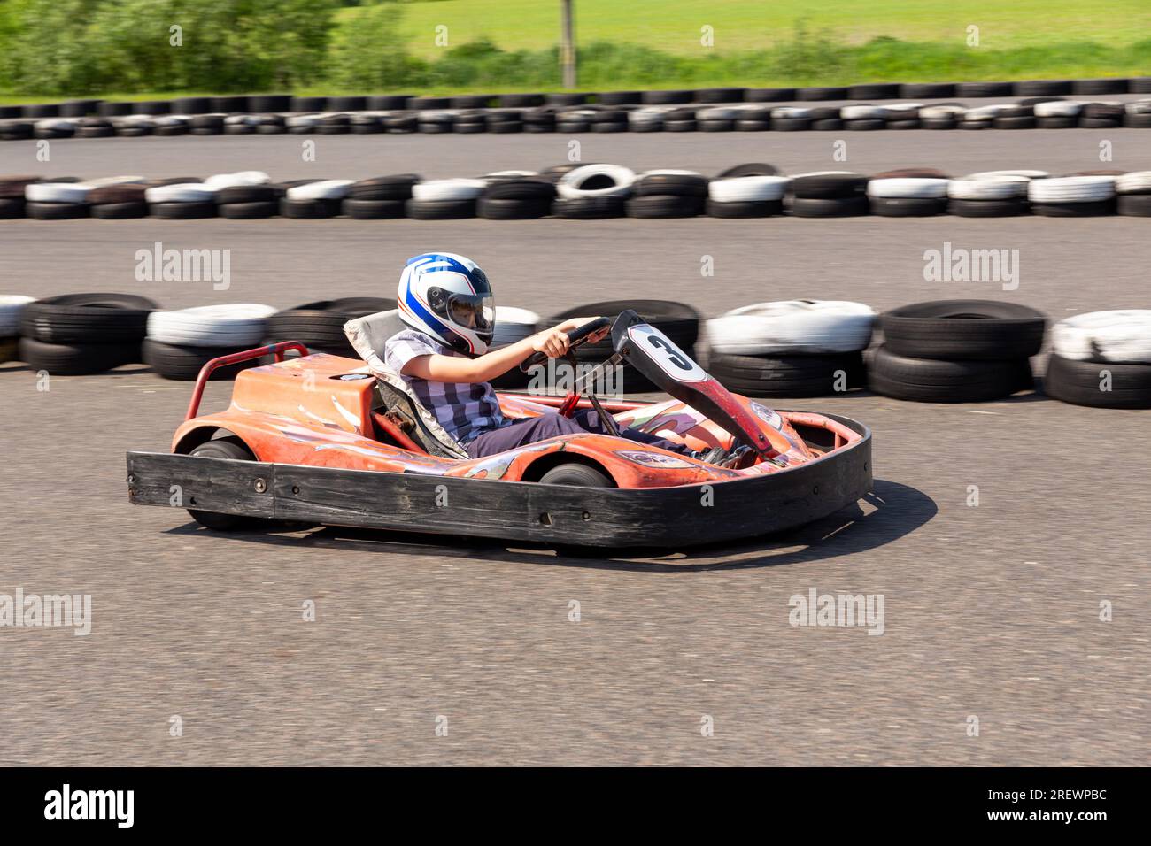 Youth Go Kart Racer on track. Dynamic image of teenage boy, moving fast ...