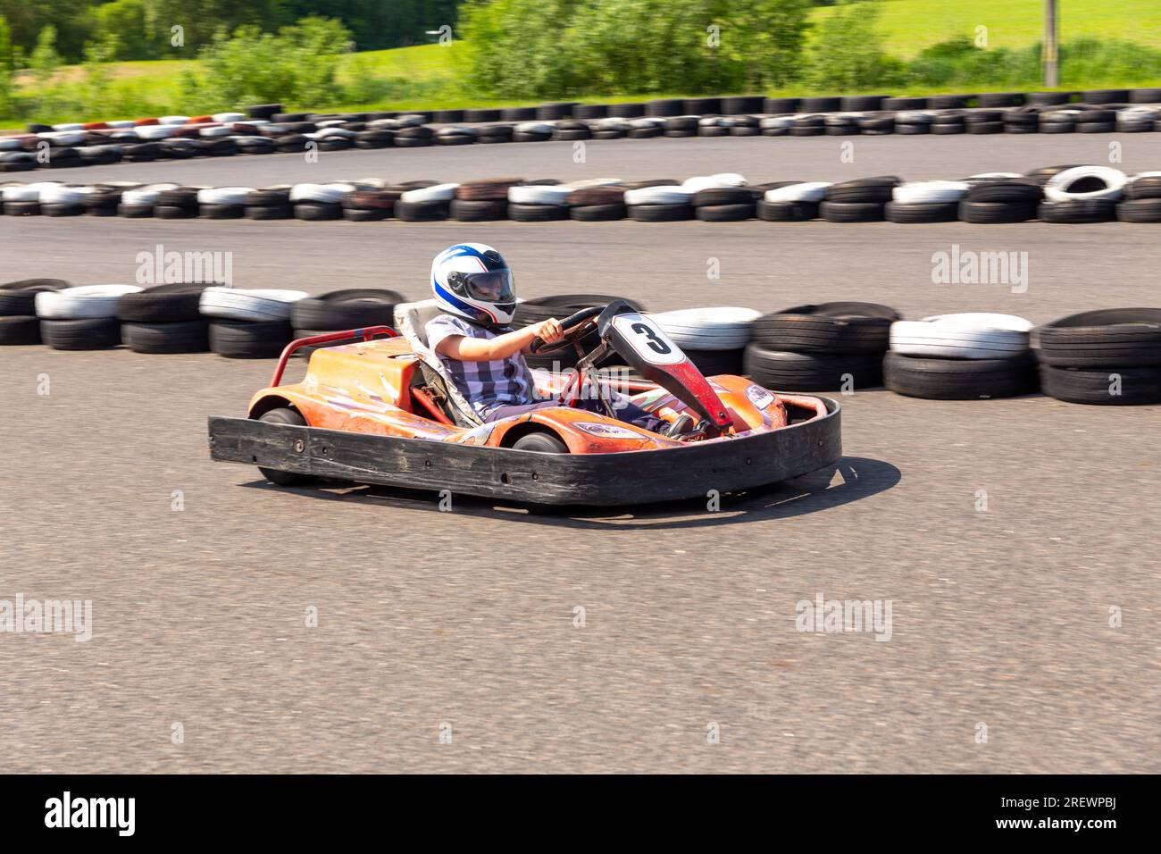 Youth Go Kart Racer on track. Dynamic image of teenage boy, moving fast ...