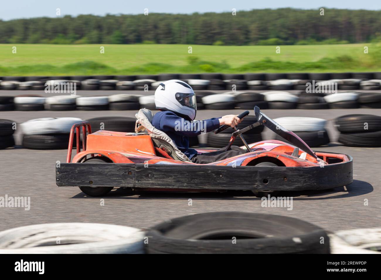 Youth Go Kart Racer on track. Dynamic image of teenage boy, moving fast ...