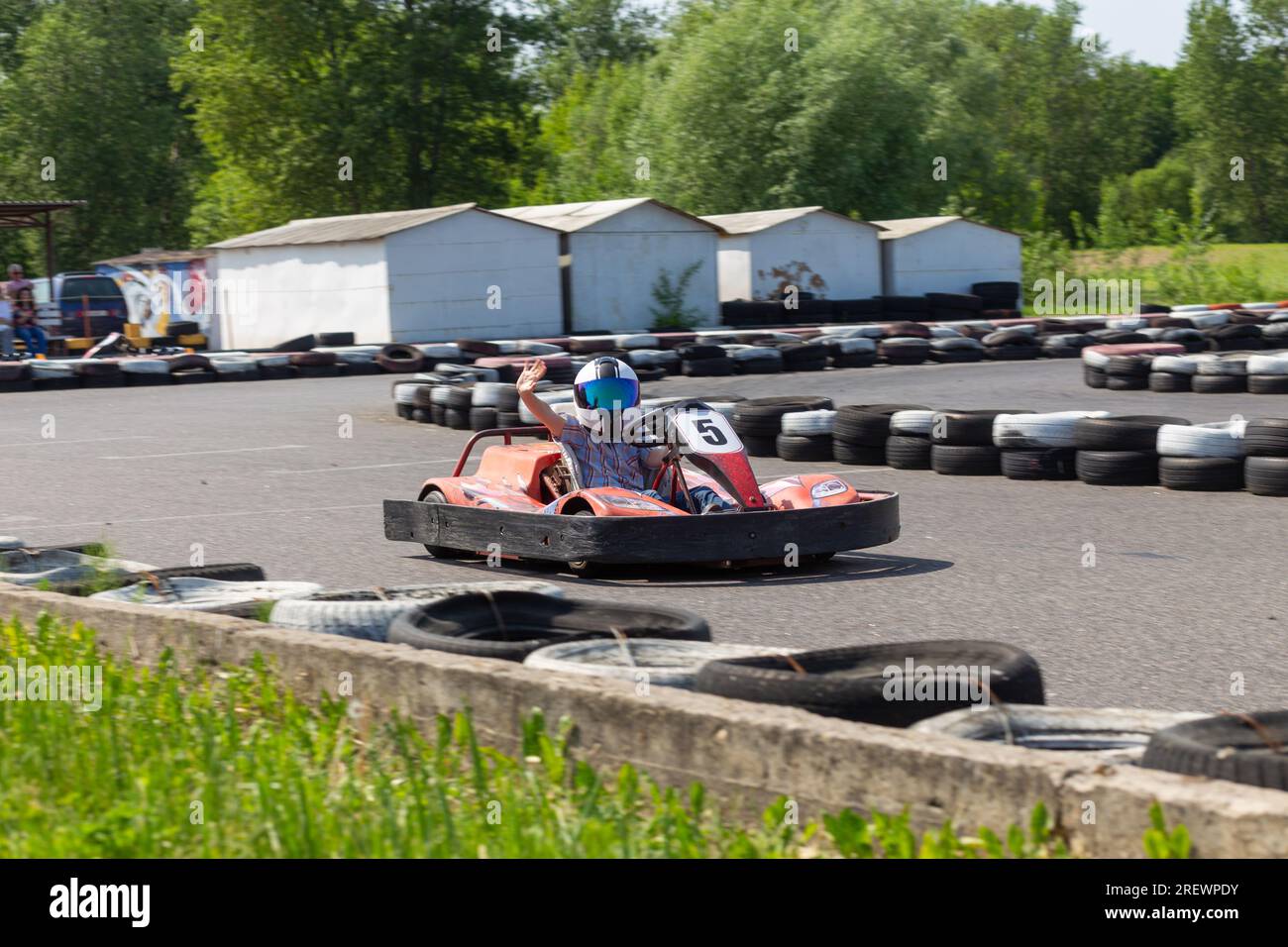 Youth Go Kart Racer on track. Dynamic image of teenage boy, moving fast ...