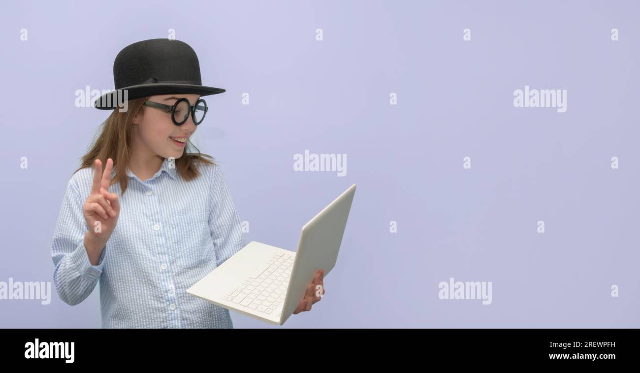 Banner of a young girl with a small white laptop in a carnival costume ...