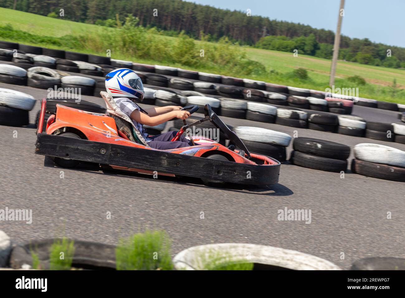 Youth Go Kart Racer on track. Dynamic image of teenage boy, moving fast ...