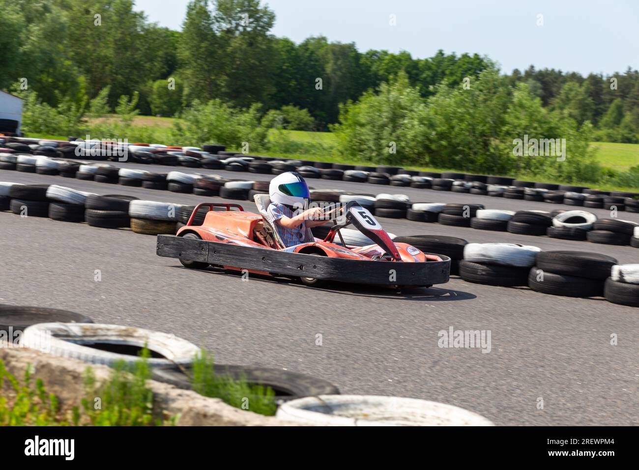 Youth Go Kart Racer on track. Dynamic image of teenage boy, moving fast ...