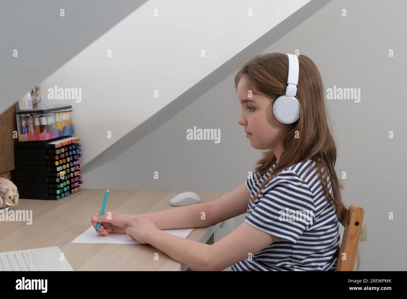 Learn a foreign language audio. Girl schoolgirl doing homework online ...