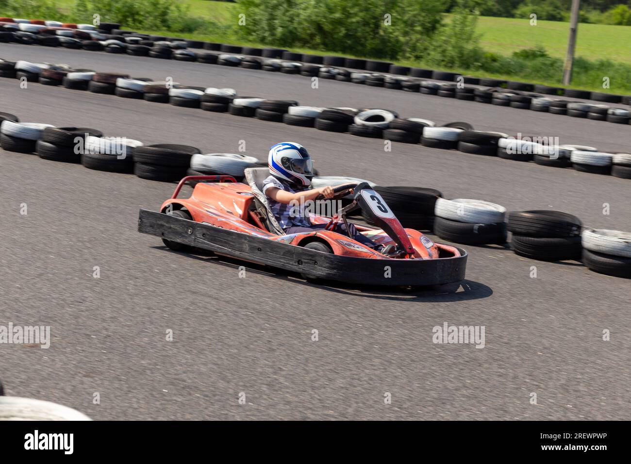Youth Go Kart Racer on track. Dynamic image of teenage boy, moving fast ...