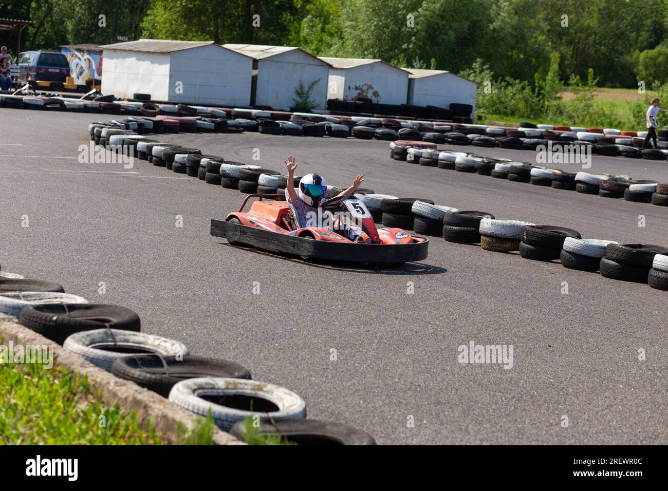 Youth Go Kart Racer on track. Dynamic image of teenage boy, moving fast ...
