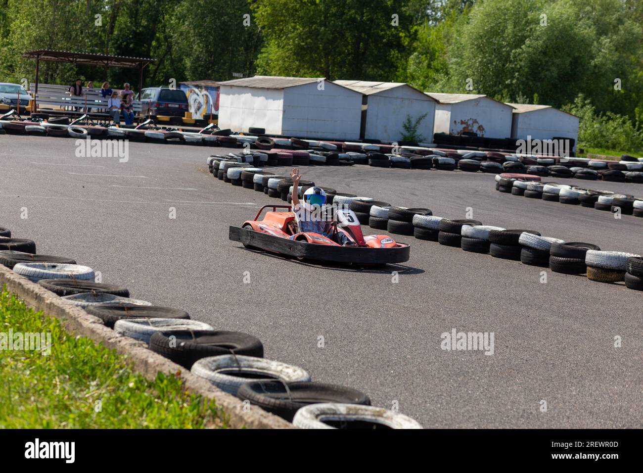 Youth Go Kart Racer on track. Dynamic image of teenage boy, moving fast ...