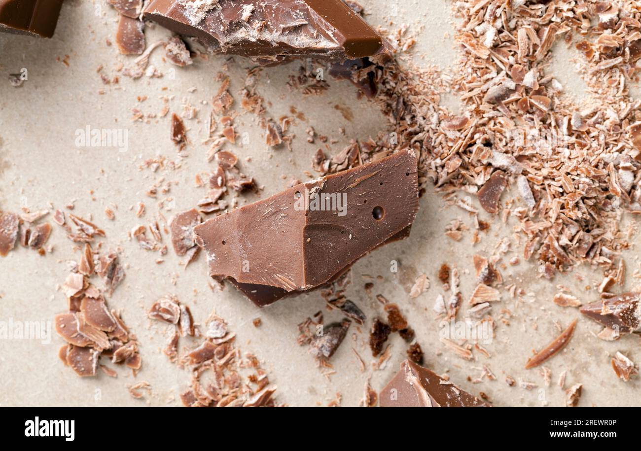 pieces of chocolate randomly scattered on the table, broken and ...