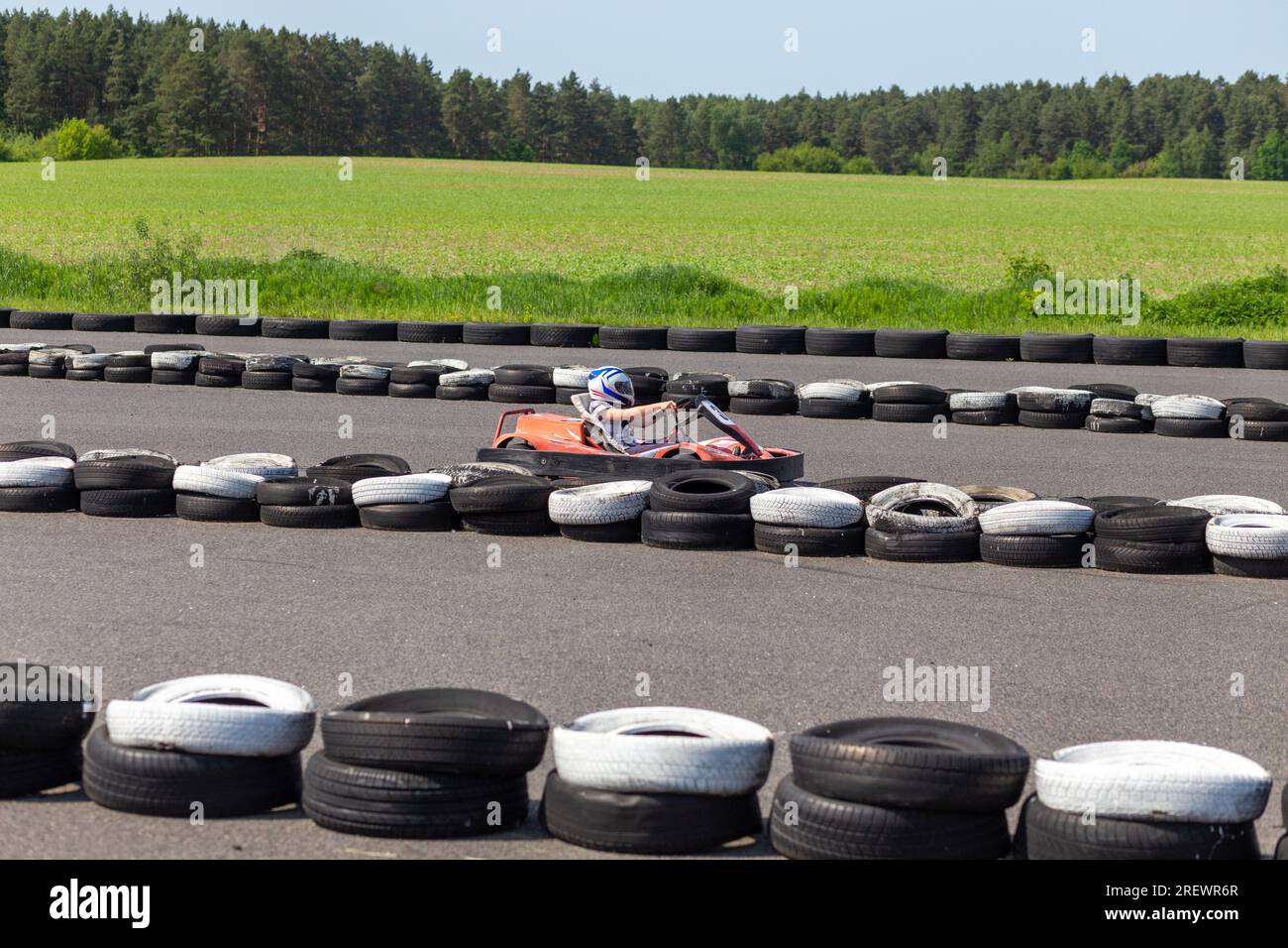 Youth Go Kart Racer on track. Dynamic image of teenage boy, moving fast ...