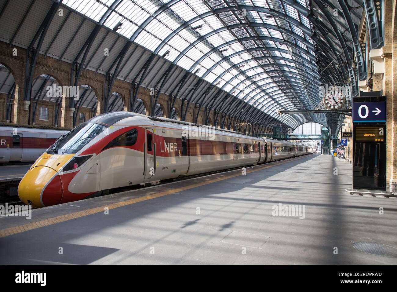 LNER Azuma train at Kings Cross station London with station clock Stock ...