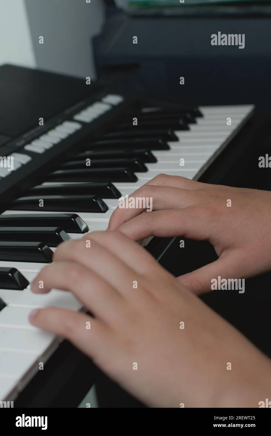 Piano exercises. Two hands playing lessons. Synthesizer keyboard close ...