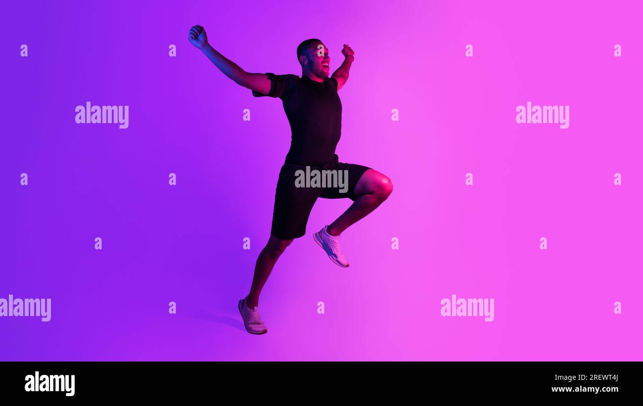 Emotional black runner shaking fists running on purple neon background ...