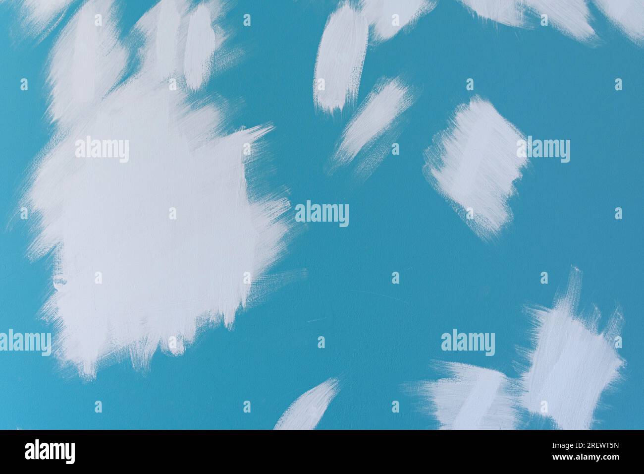 Smears of white paint from a paint brush on a blue wall. Creative ...
