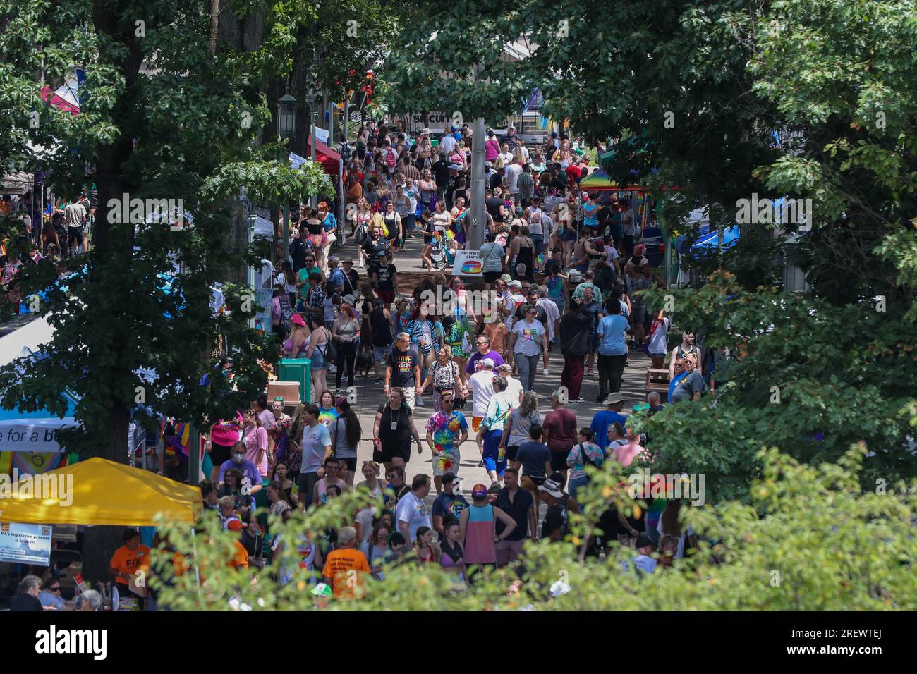 A large crowd of people walks through the 2023 Pride Festival of ...