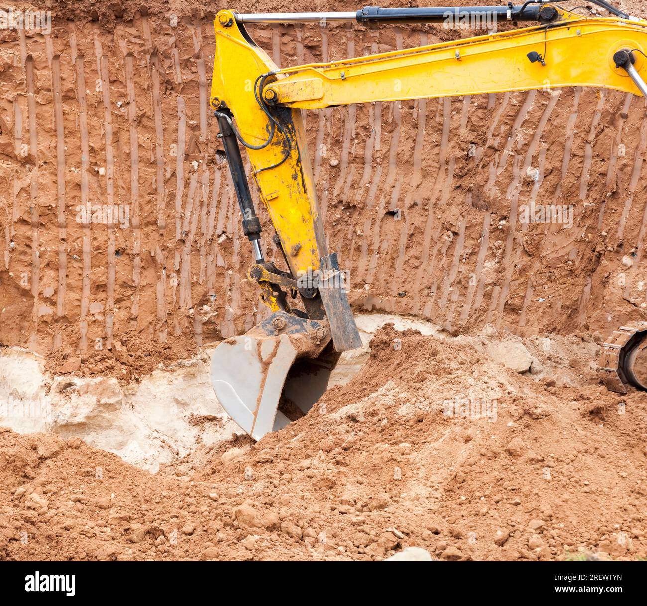part of a tractor with a bucket that digs up the soil and territory for ...