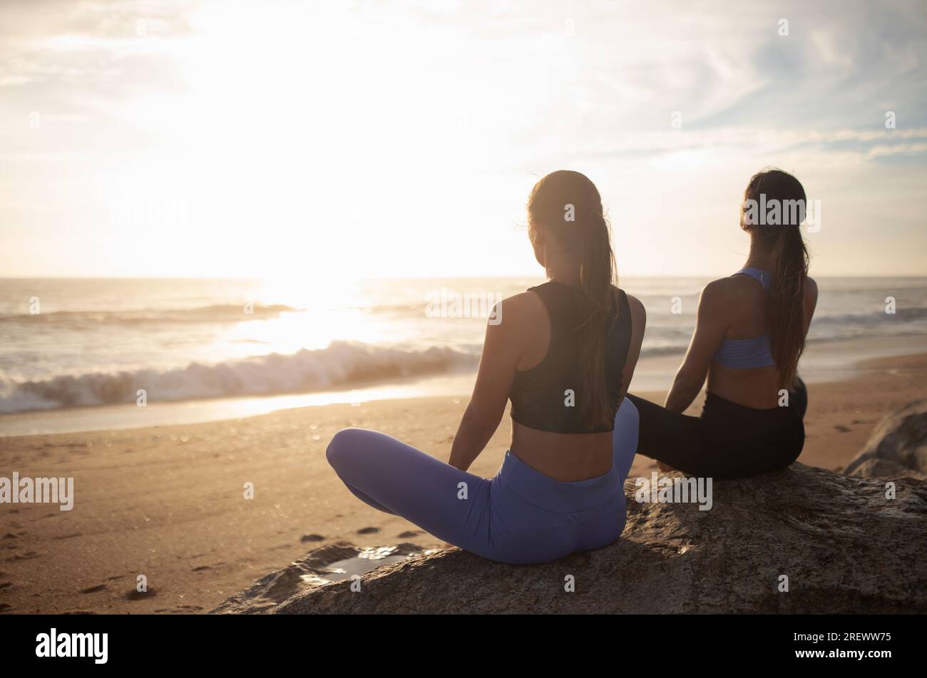 Millennial caucasian twins sisters women practice yoga in lotus ...