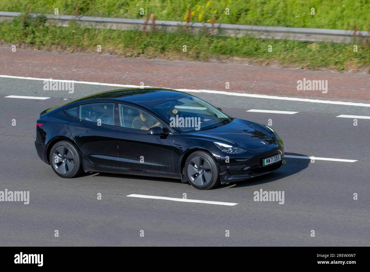 2021 Black Tesla Model 3 Long Range AWD, travelling at speed on the M6 ...