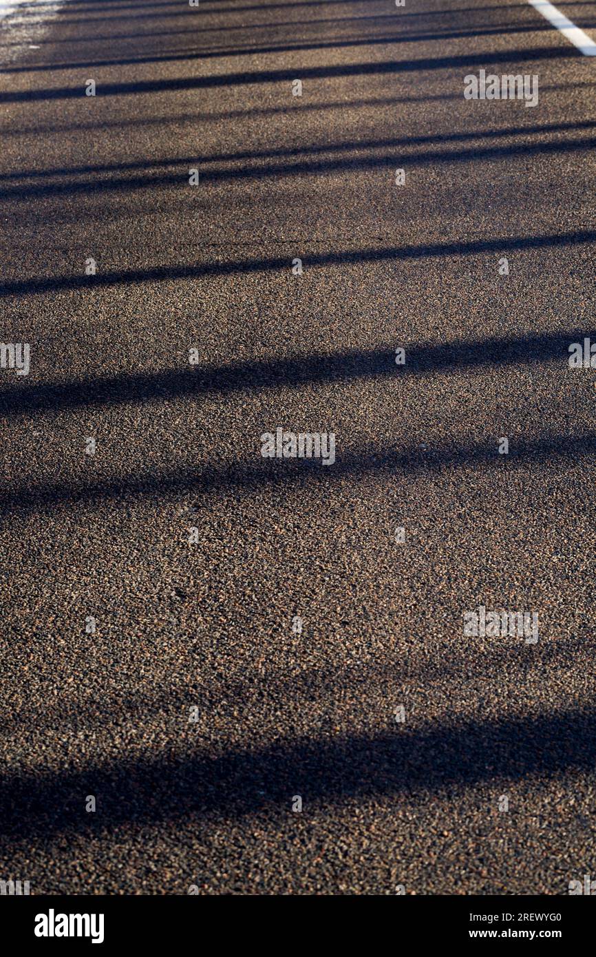 an old paved road with white road markings, the road is narrow and ...