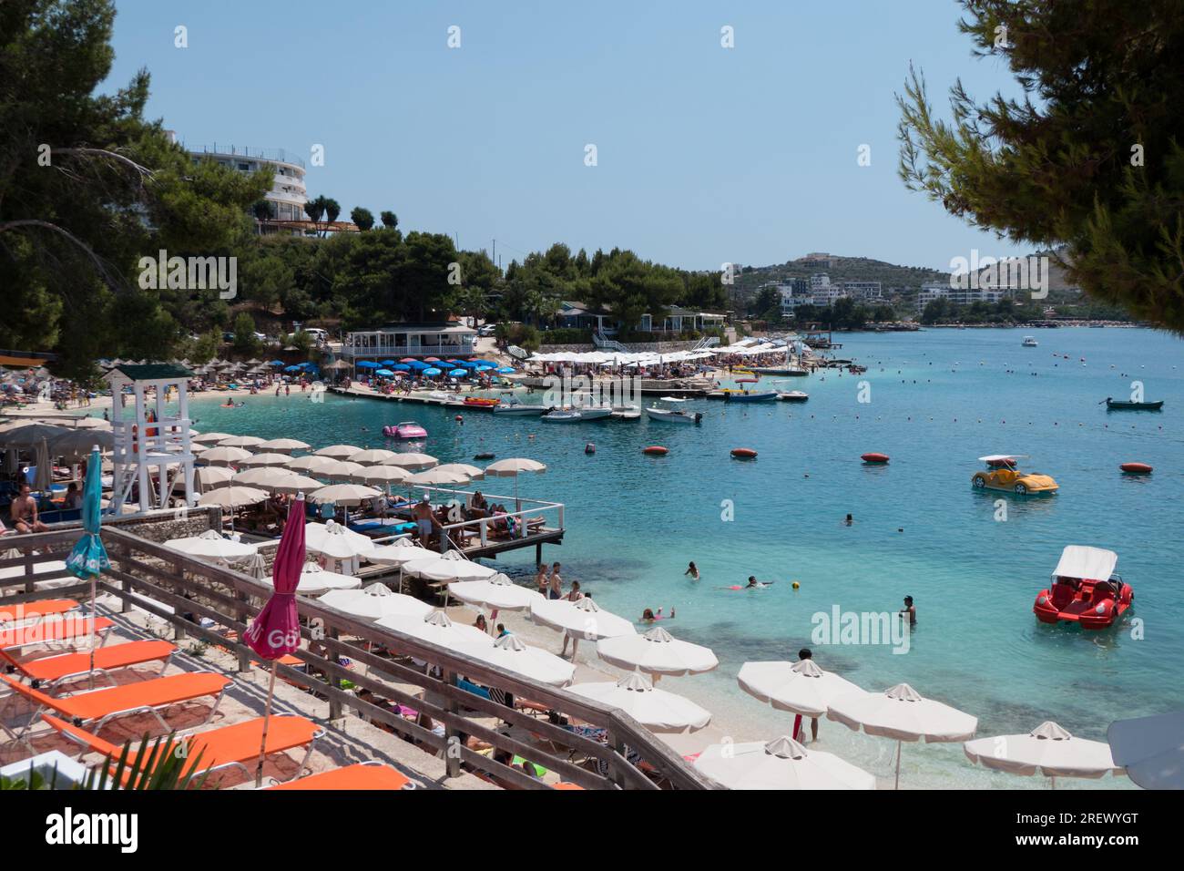 View of crowded beach in Ksamil, Albania with people swimming and ...