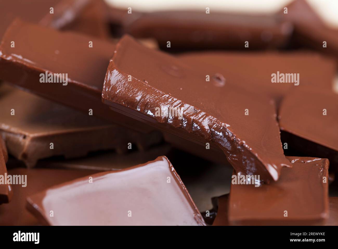 milk and bitter chocolate together are broken into pieces with a melted ...