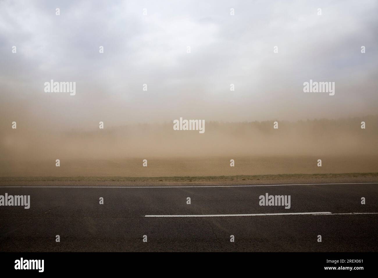 a strong wind has picked up a large amount of sand from the fields and ...