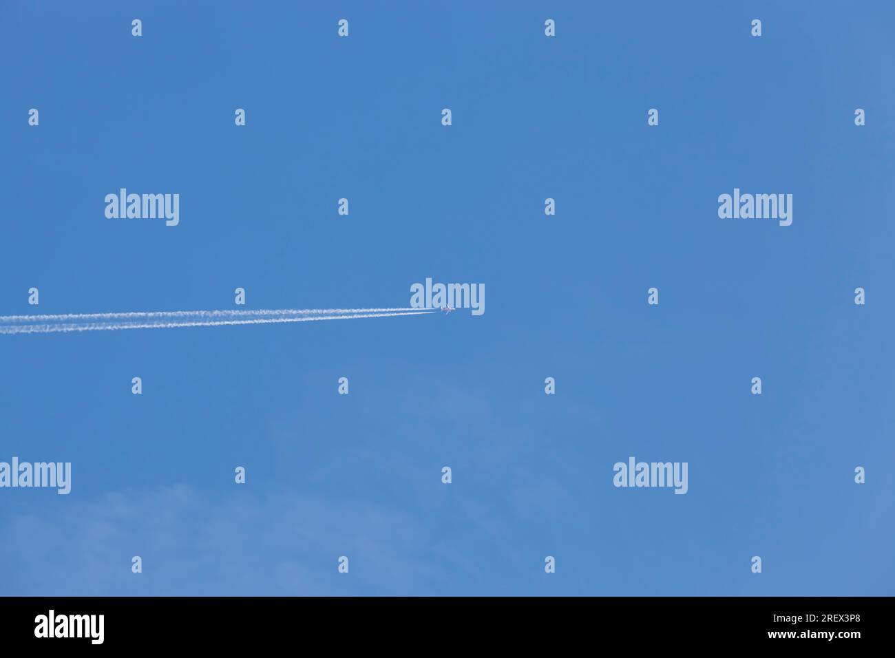 passenger plane flying in the blue sky, fast transport leaves behind a ...