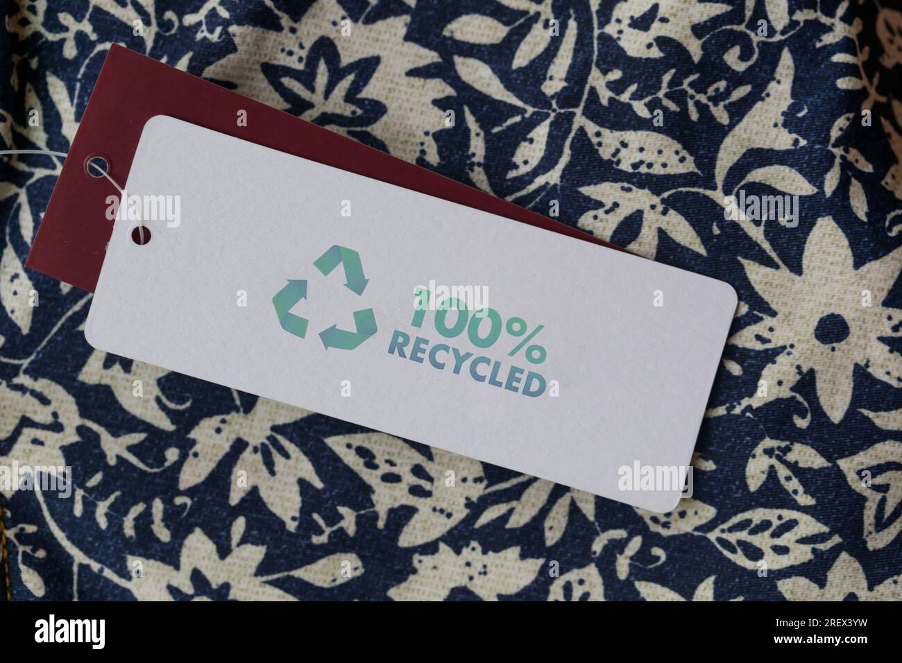 Close up of clothing tag with recycle icon. Recycling products concept ...