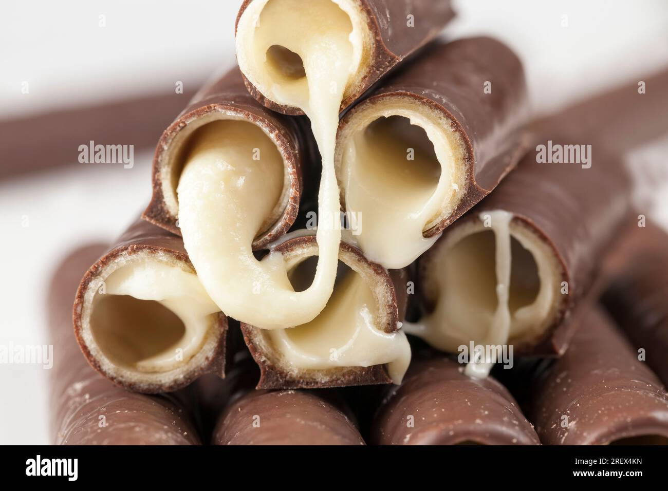milk filling flows out of waffle tubes in chocolate, chocolate covered ...