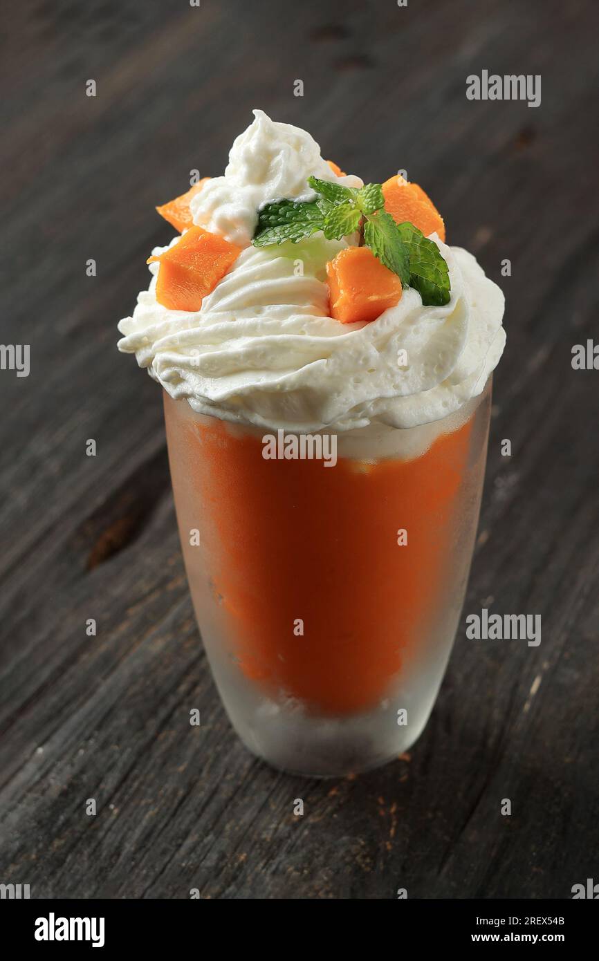 Orange Mango Smoothie with Whip Cream Topping, King Mango Summer Fresh Drink Stock Photo - Alamy