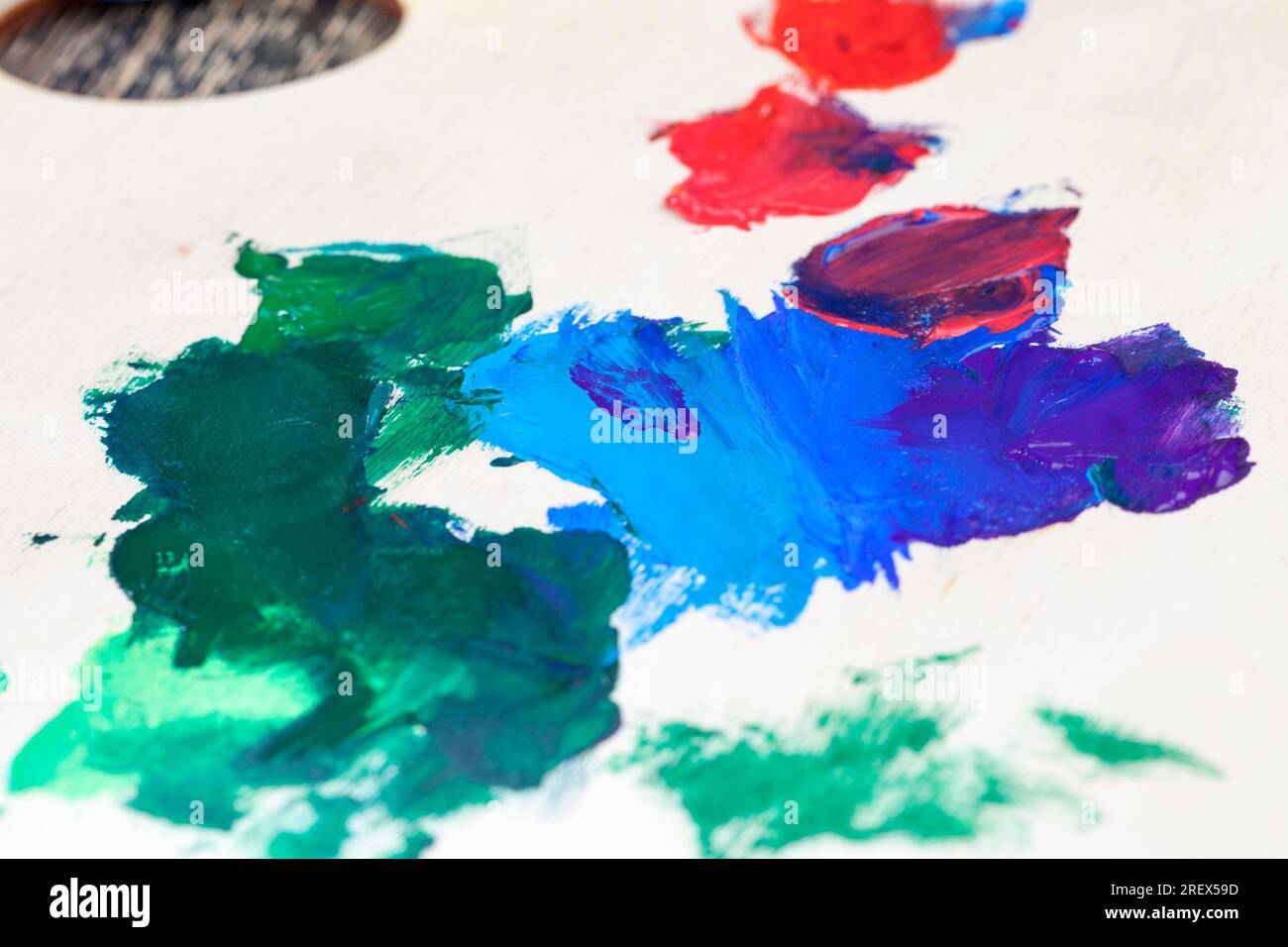 mixed on a wooden palette of multi colored paints, the paint is used ...