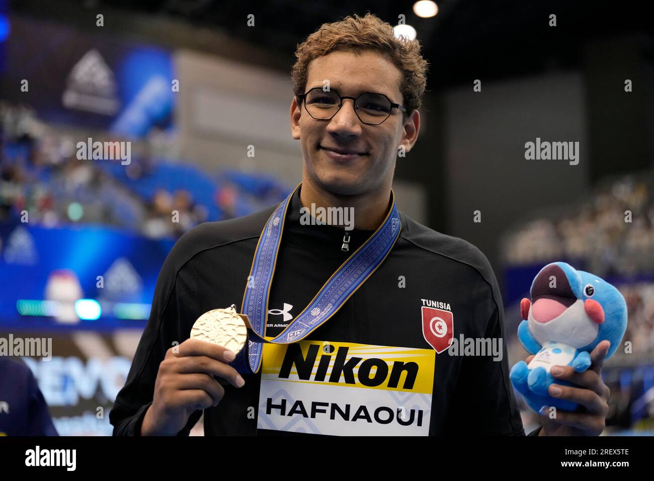 Gold medalist Tunisia's Ahmed Hafnaoui celebrates during the medal ...