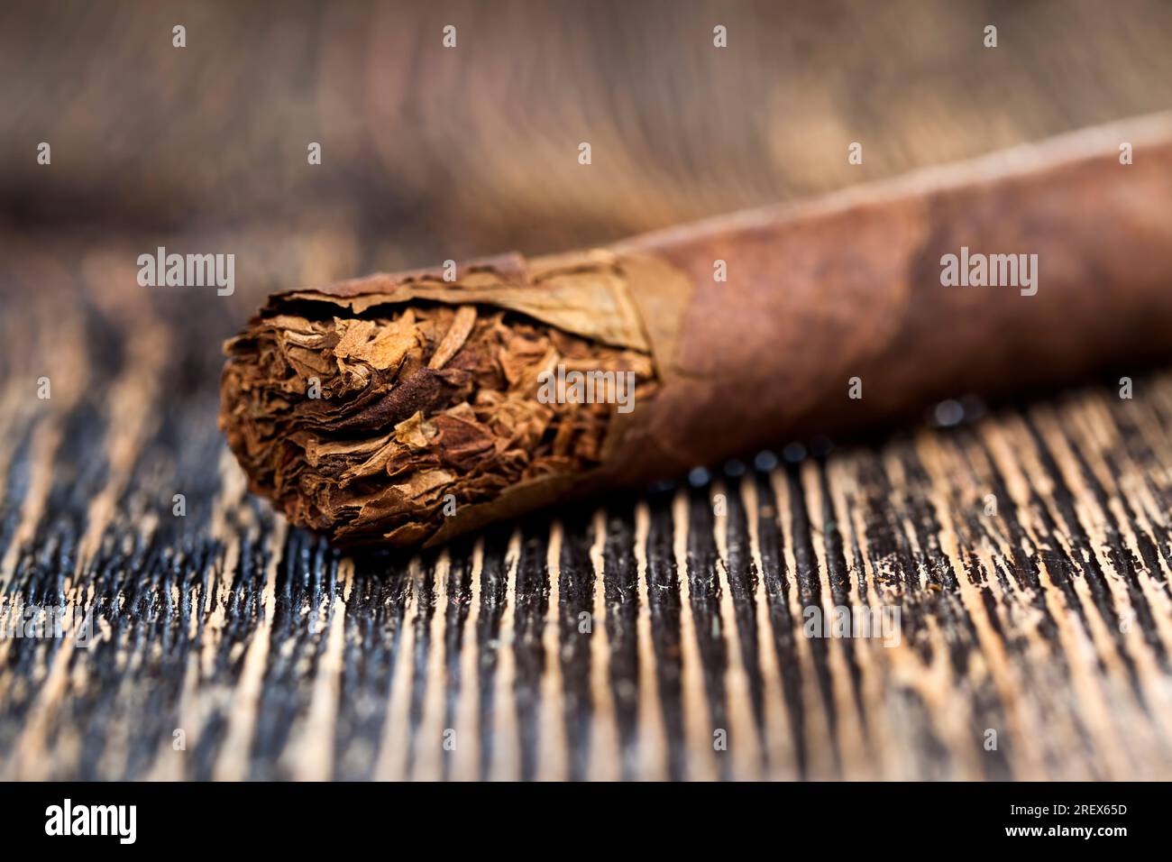 tobacco from a crumbling cigarette on the board, dangerous tobacco from ...