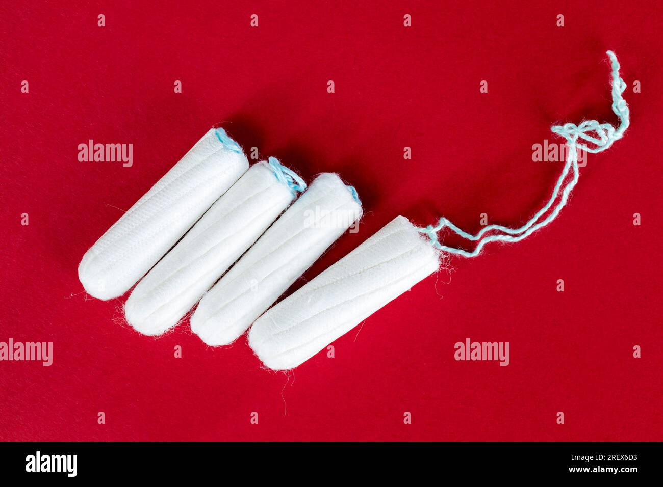 women's sanitary tampon on a red background, sanitary tampon made of ...