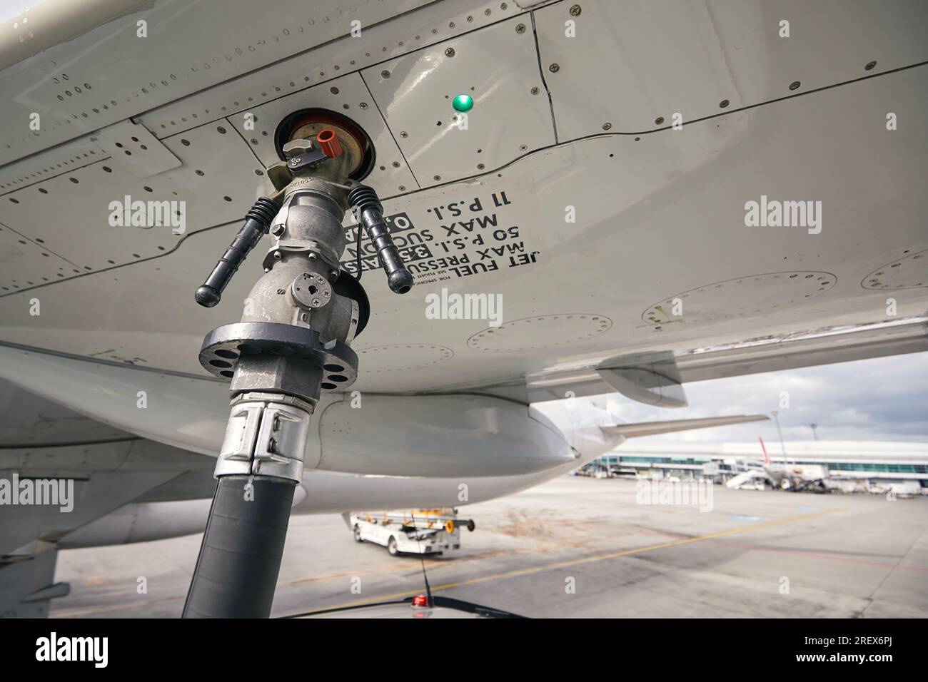 Close-up refueling of airplane at airport. Ground service before flight ...