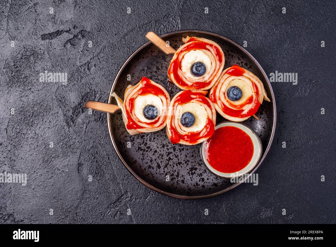 Monster Bloody Eyeballs for Halloween. Crepes roll up with banana and ...
