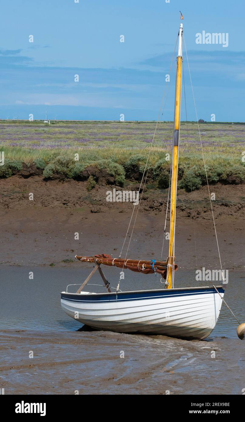 Stifles (wooden sailing dinghy) and salt marsh at low tide at Blakeney ...