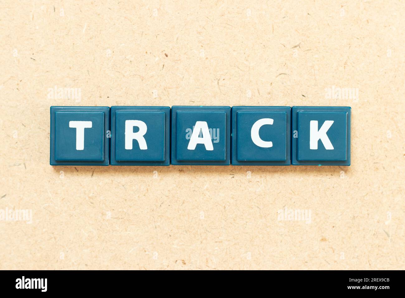 Tile alphabet letter in word track on wood background Stock Photo - Alamy