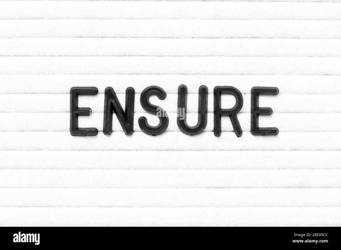 Black color letter in word ensure on white felt board background Stock ...