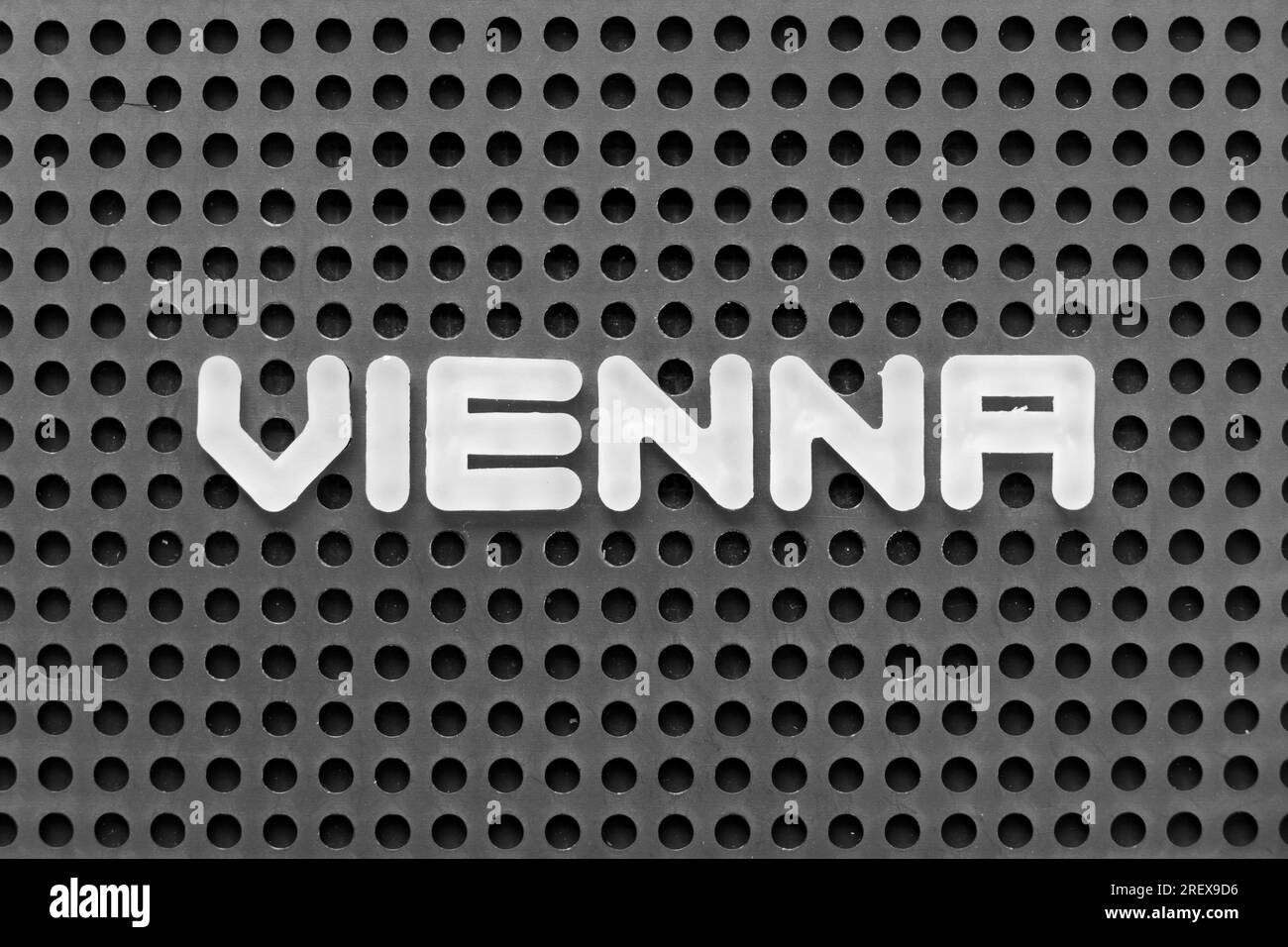 White alphabet letter in word vienna on black pegboard background Stock ...