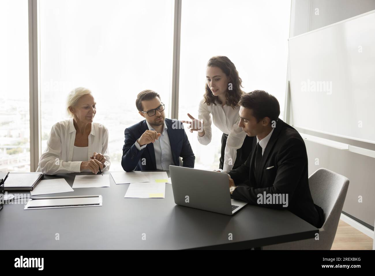 Professional colleagues working on project together, watching project ...