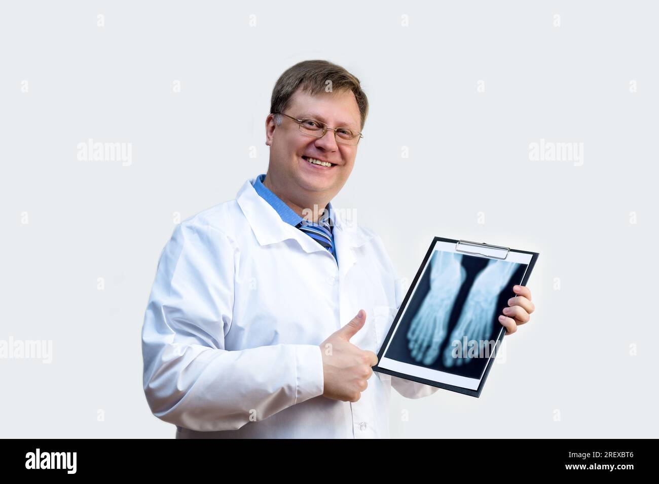 Male doctor examines an x-ray white gray background Stock Photo - Alamy