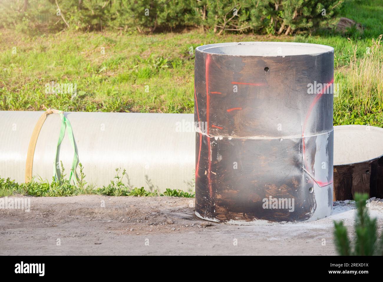 Concrete pipes on the side of the reconstructed road. Large concrete ...