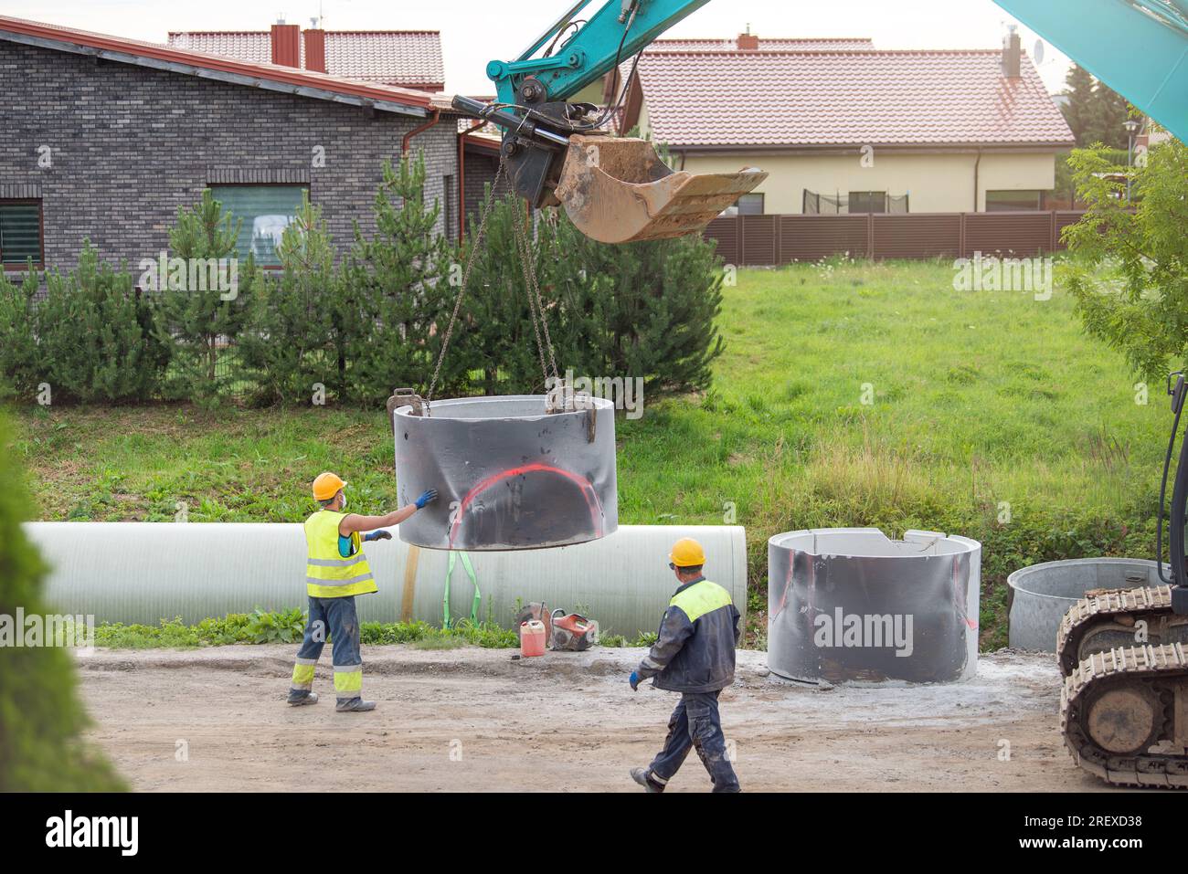 Workers are working on the construction site. An excavator uses a chain ...