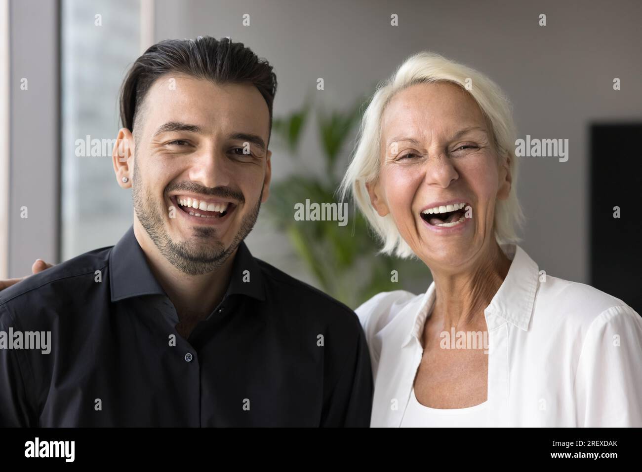 Happy proud retired senior mom hugging cheerful adult son Stock Photo ...