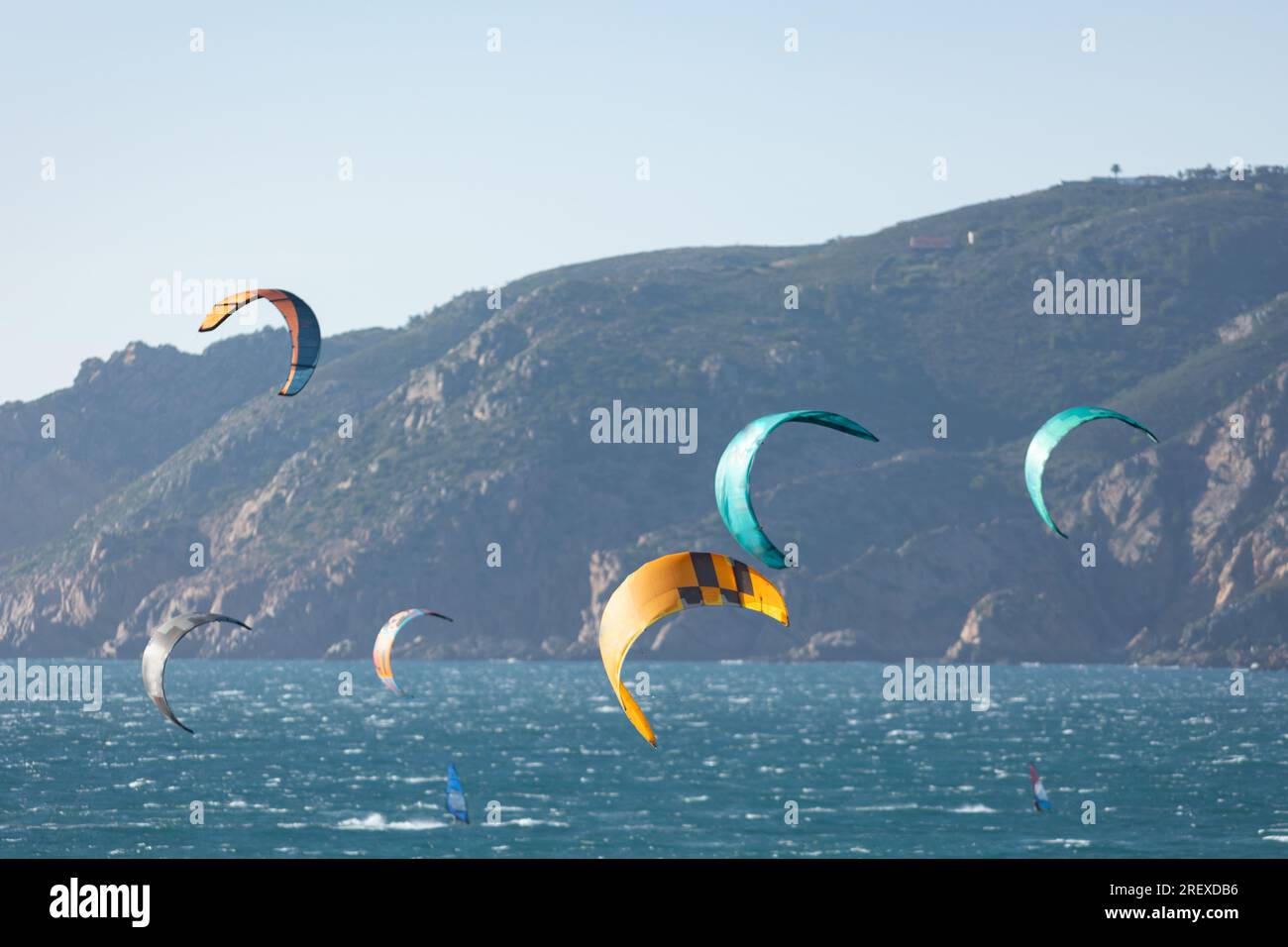 Colorful paragliders over the blue ocean. Mid shot Stock Photo - Alamy