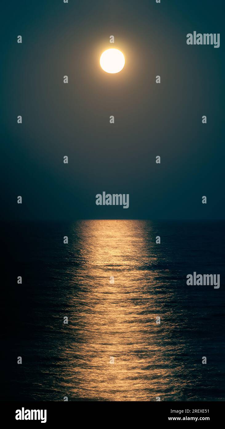 Vertical background - a beautiful moonlit path on the sea, full moon ...