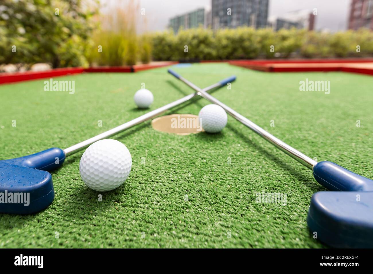 Fun vacation entertainment for summertime. Playing mini golf on green ...
