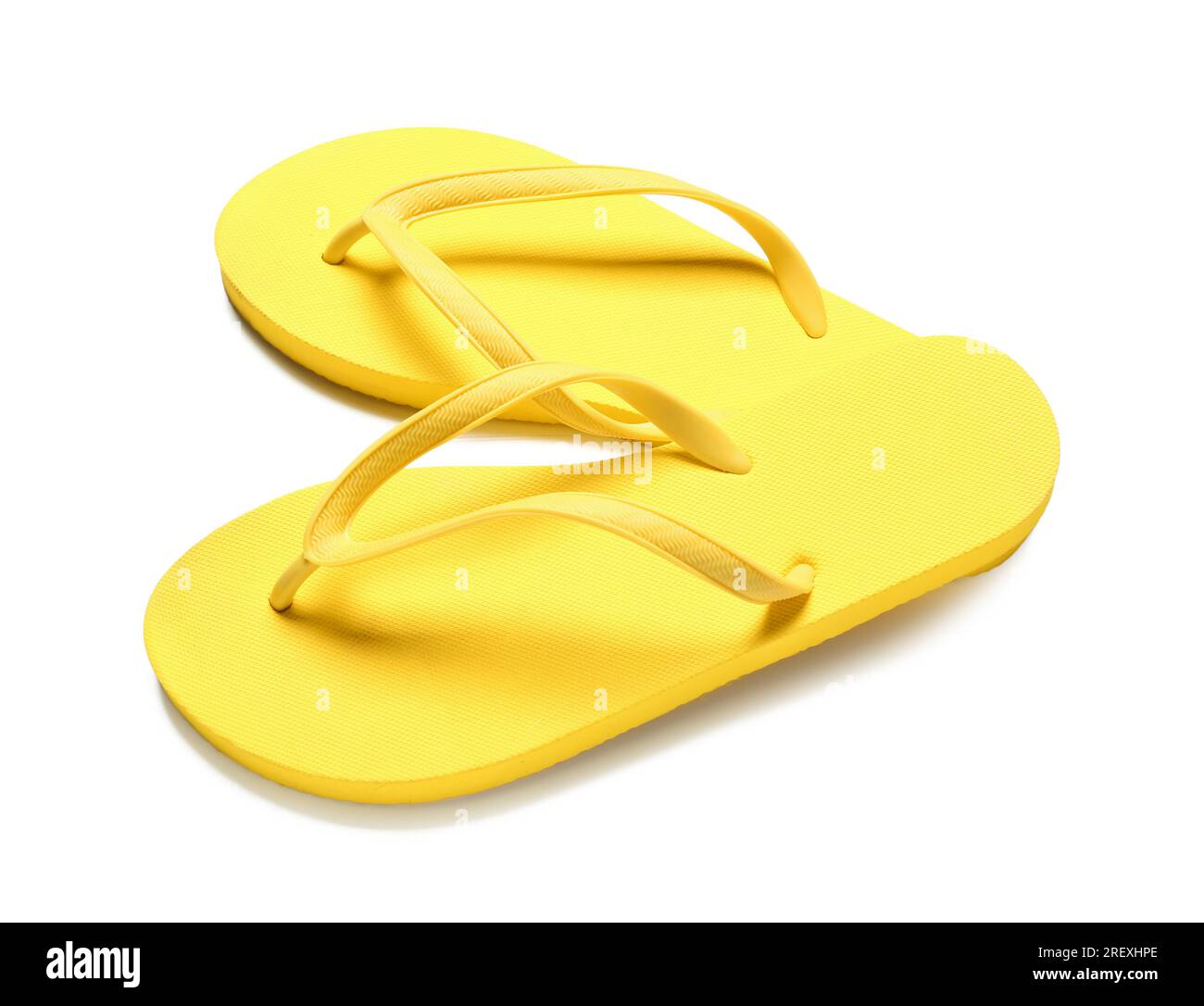 Pair of yellow flip-flops on white background Stock Photo - Alamy